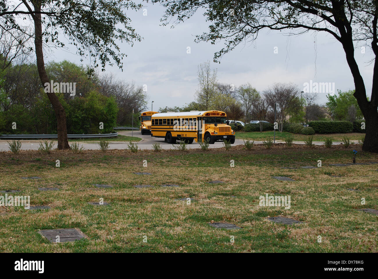 Yellow school buses leave a bus barn for the after noon trip from ...
