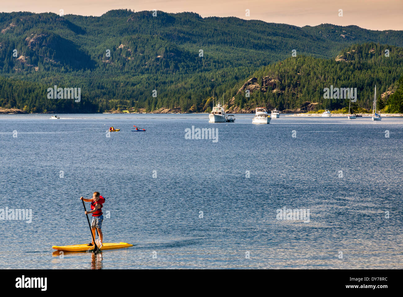 Young boy standing up, paddleboarding, Rebecca Spit Provincial Marine ...