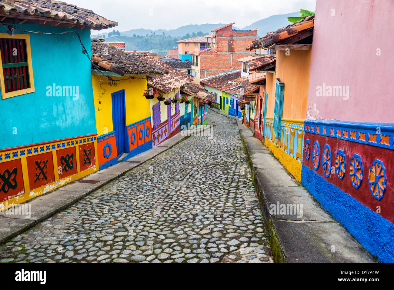 Colorful colonial houses on a cobblestone street in Guatape, Antioquia ...