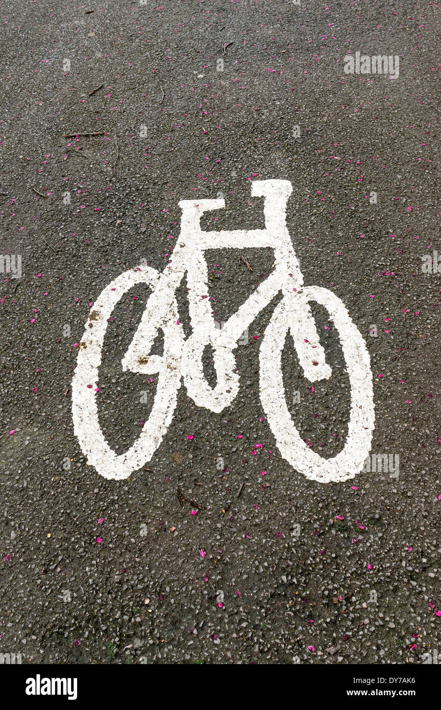 Cycle path sign painted in white paint on black tarmac surface Stock ...