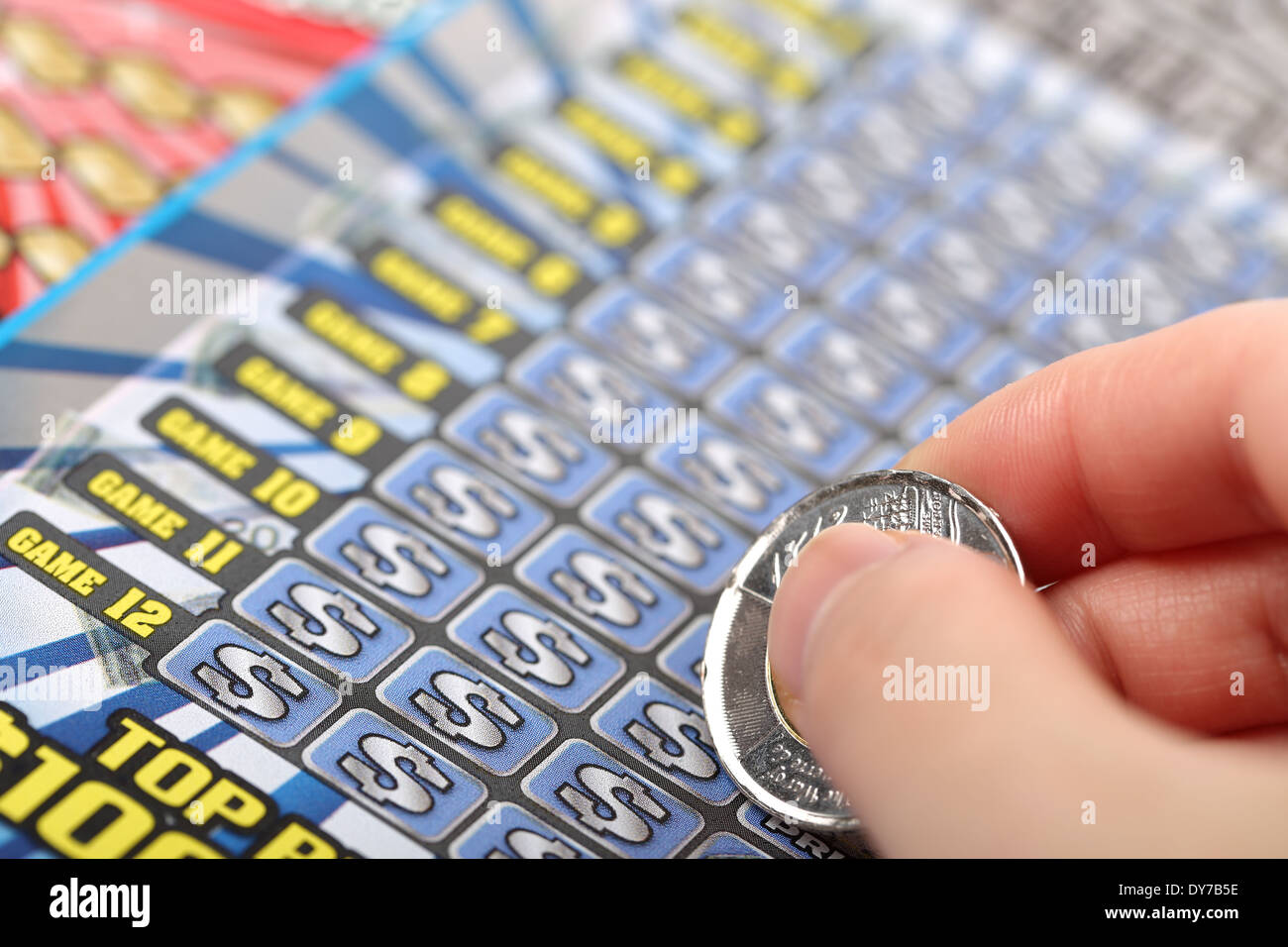 Scratching lottery ticket Stock Photo - Alamy