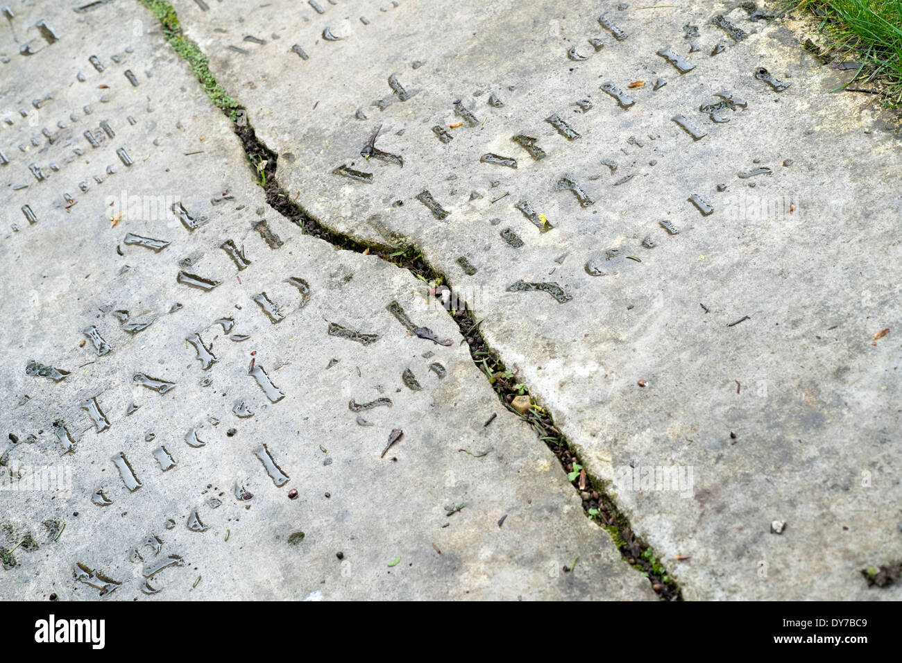 Crack in memorial stone used as a paving stone in a path Stock Photo ...