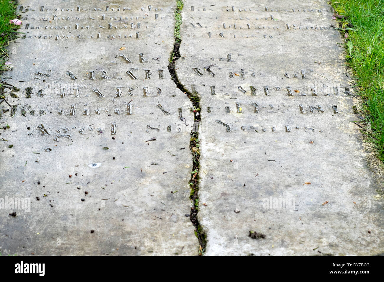 Crack in memorial stone used as a paving stone in a path Stock Photo ...