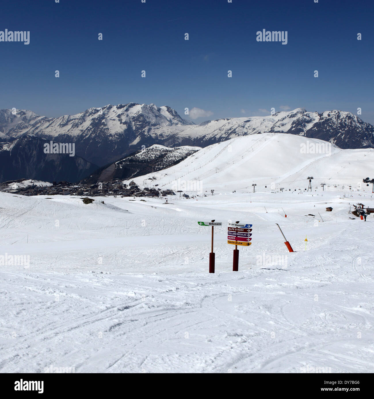 Signs and a snow covered Alpine skiing piste at Alpe d'Huez, France ...