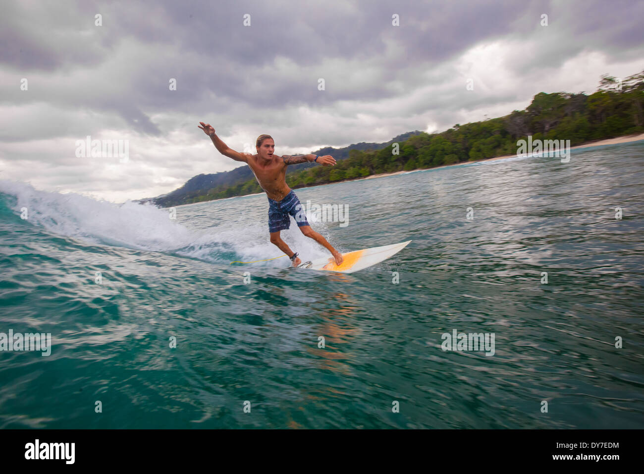Surfing a wave. GLand surf area.Java island.Indonesia Stock Photo - Alamy