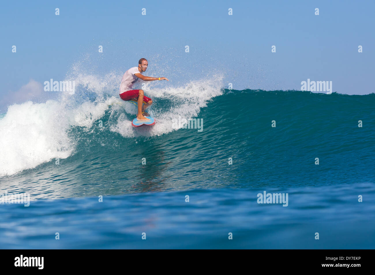 Surfing a wave in Indian ocean Stock Photo - Alamy