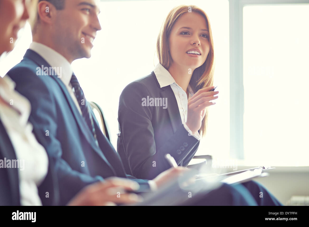 Smart businesswoman asking question at seminar with her colleagues near ...