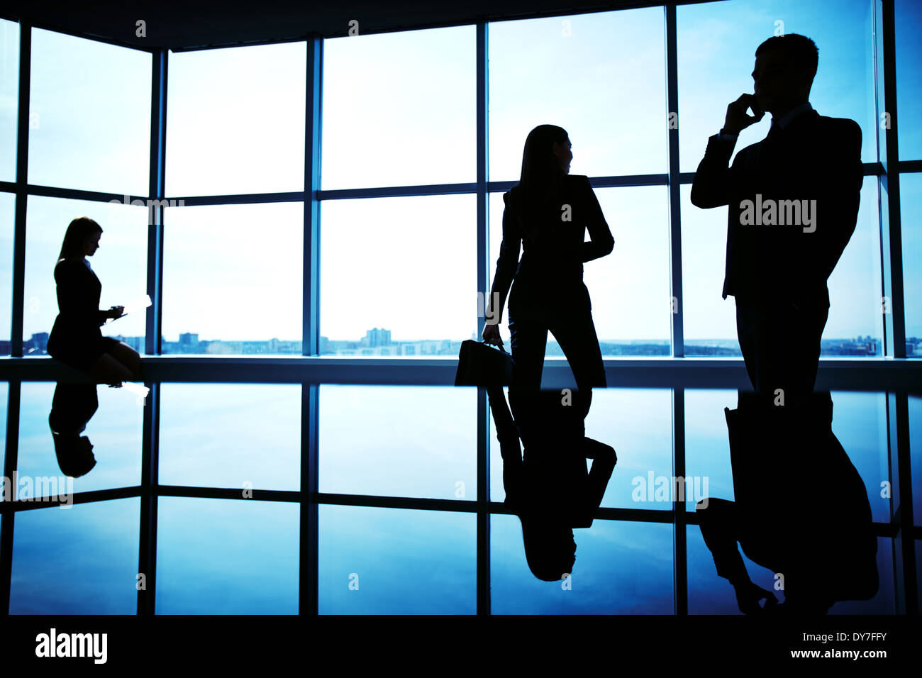 Silhouettes of several office workers working in office Stock Photo - Alamy