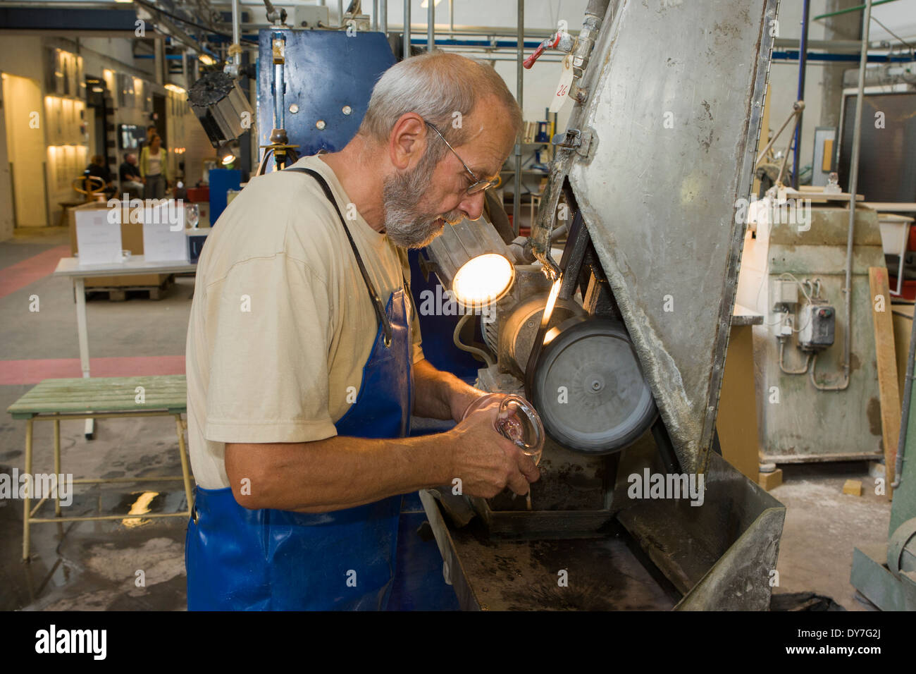 A man polish glass at a glassworks Stock Photo - Alamy