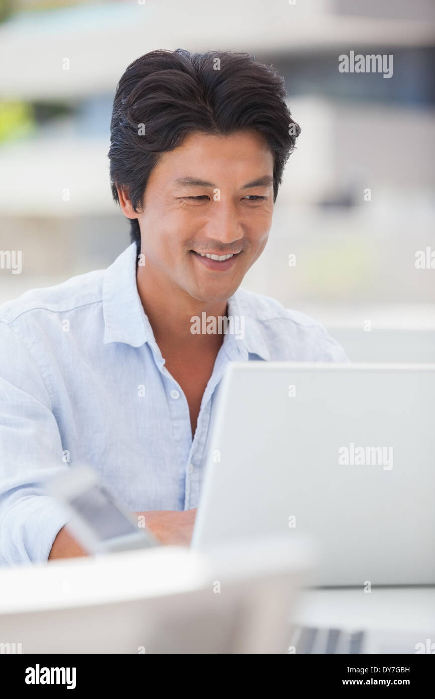 Happy man using his laptop Stock Photo - Alamy