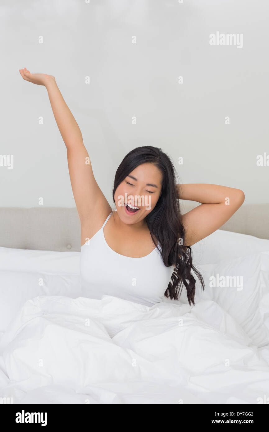 Woman yawning stretching in bed hi-res stock photography and images - Alamy