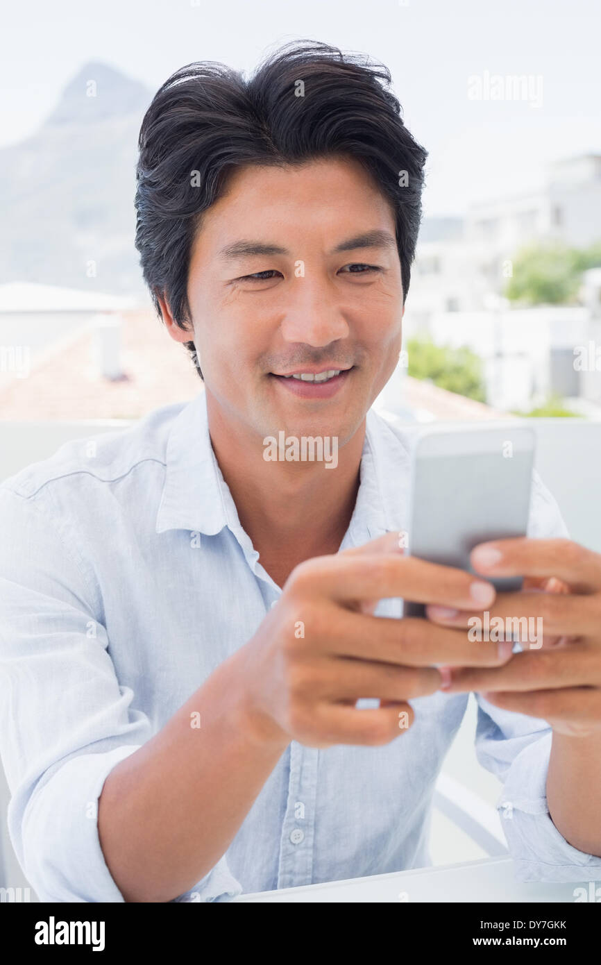 Happy man texting on phone Stock Photo - Alamy