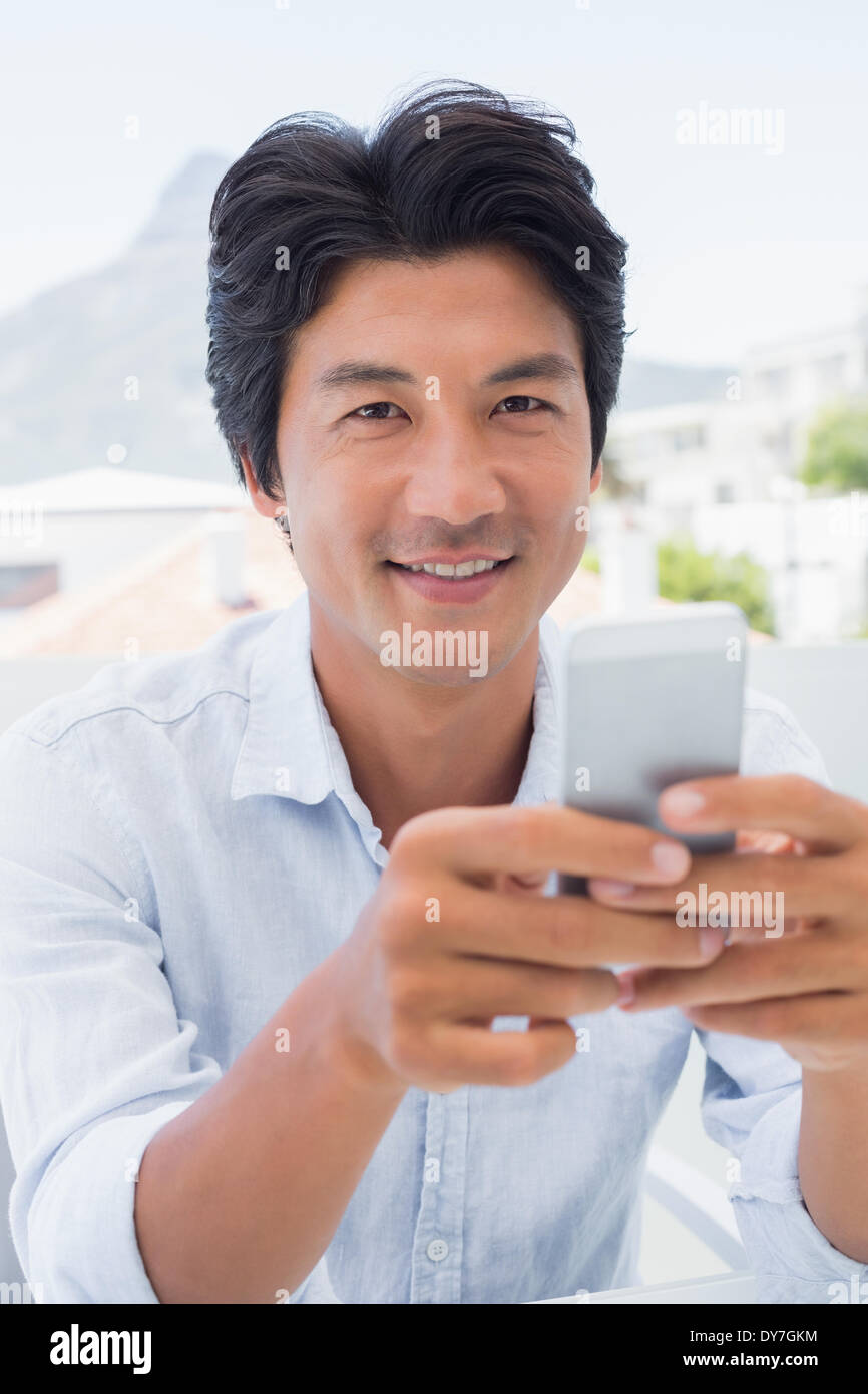 Happy man texting on phone Stock Photo - Alamy