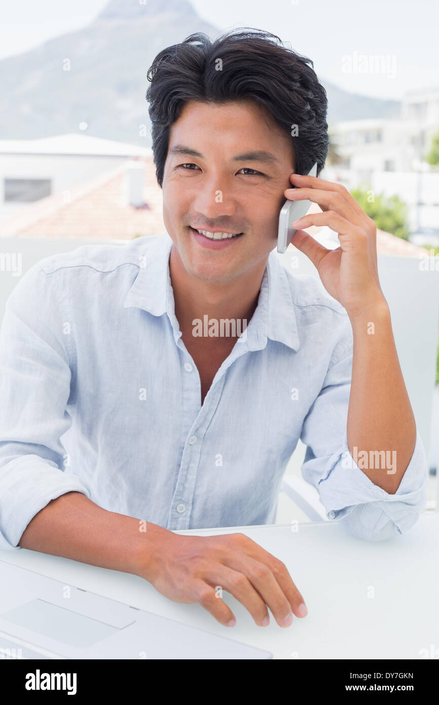 Happy man talking on phone Stock Photo - Alamy