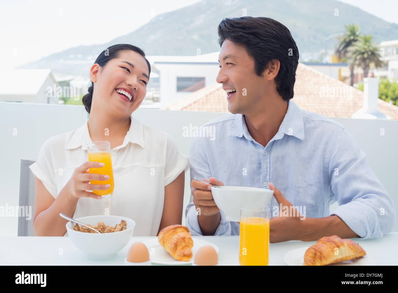Smiling couple having breakfast together Stock Photo - Alamy