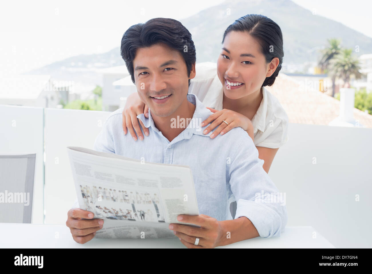 Couple reading a newspaper together Stock Photo - Alamy