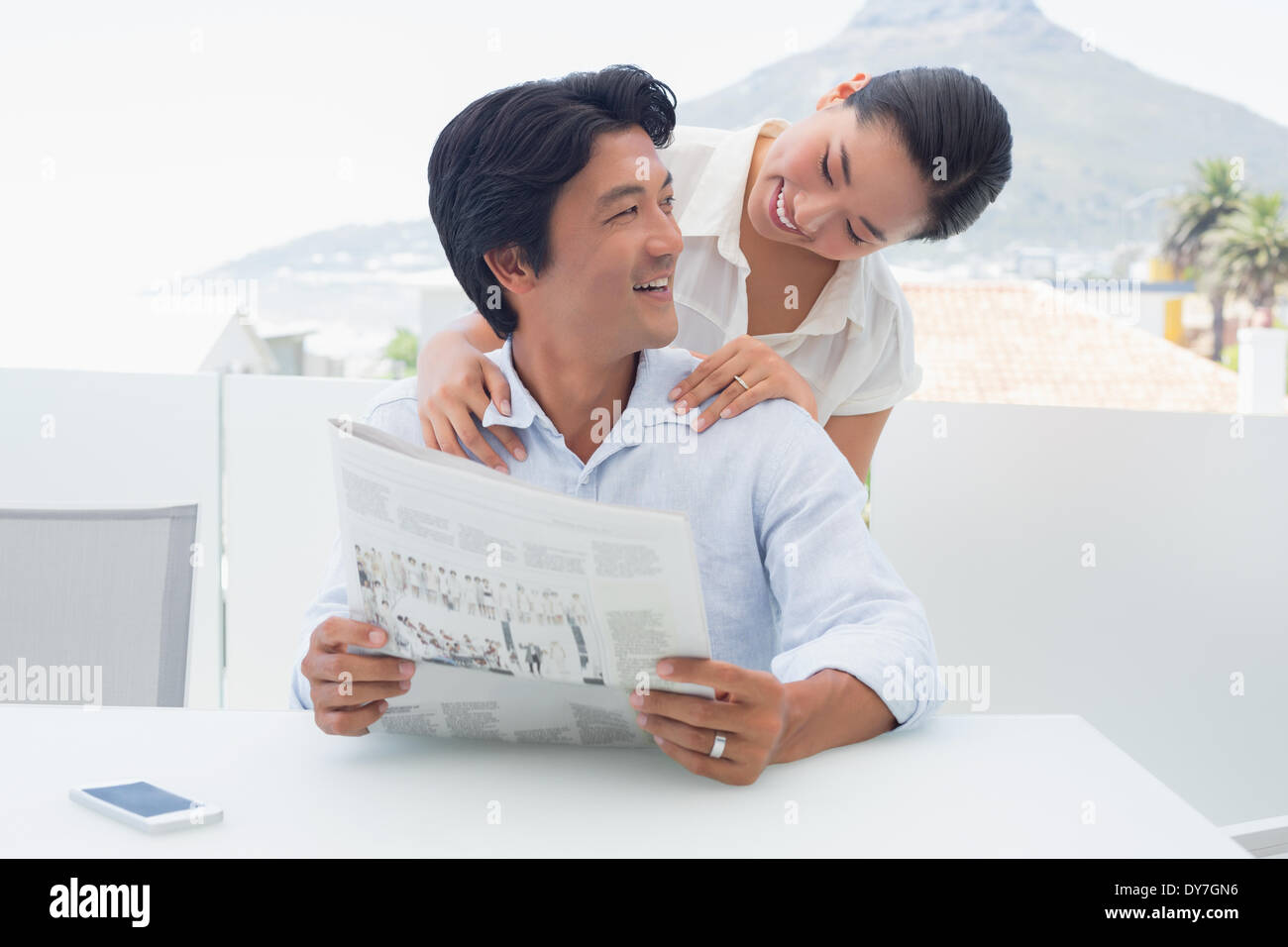 Couple reading a newspaper together Stock Photo - Alamy