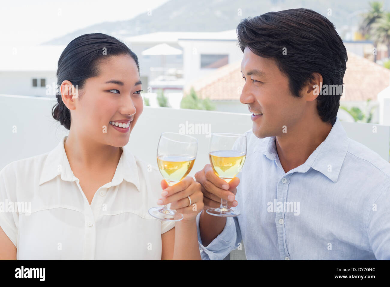 Happy couple having white wine Stock Photo - Alamy