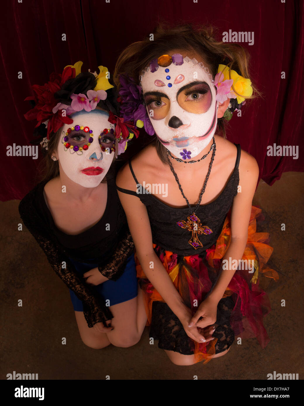 Teens dressed in Day of The Dead costumes and colorful make up pose ...
