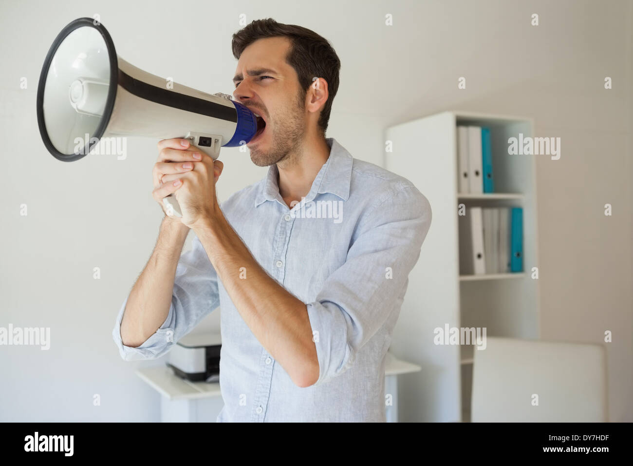 angry businessman with megaphone Stock Photo - Alamy