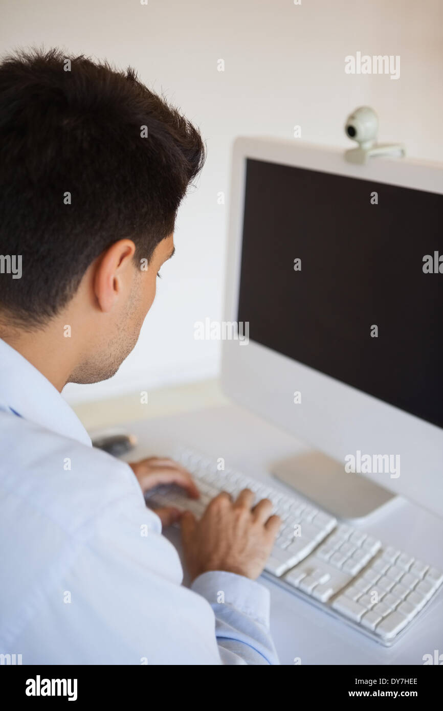 Casual businessman typing at his desk Stock Photo - Alamy