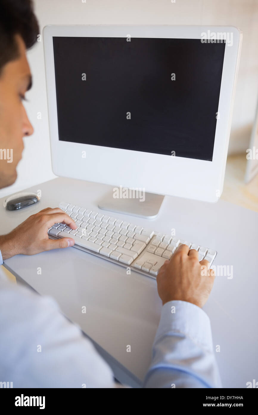 Businessman typing on keyboard at desk Stock Photo - Alamy