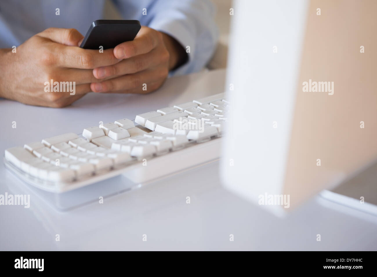 Businessman texting on smartphone sitting hi-res stock photography and ...