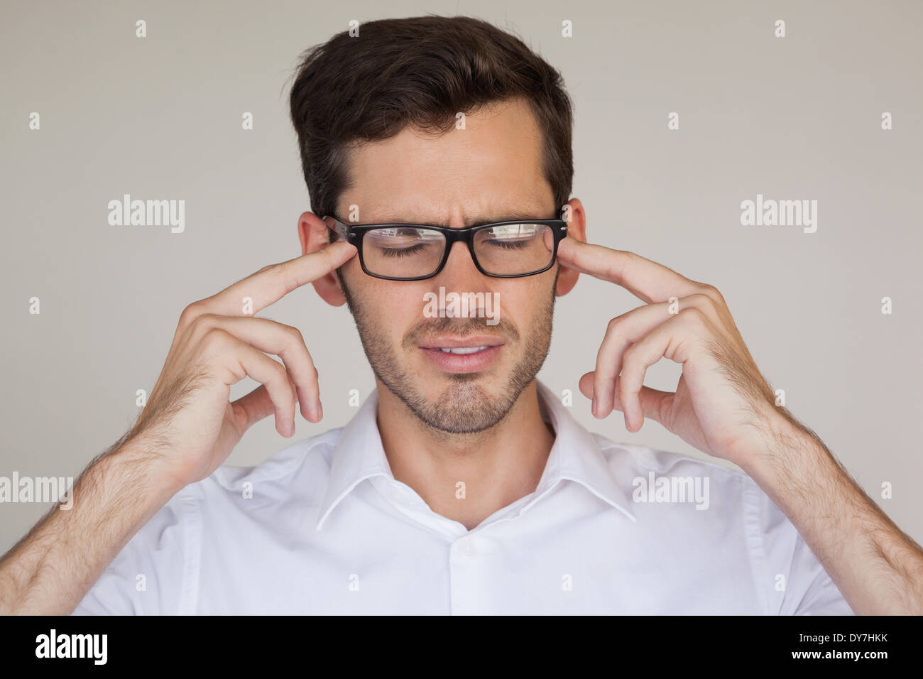 Casual businessman getting a headache Stock Photo - Alamy Casual businessman getting a headache Stock Photo - Alamy