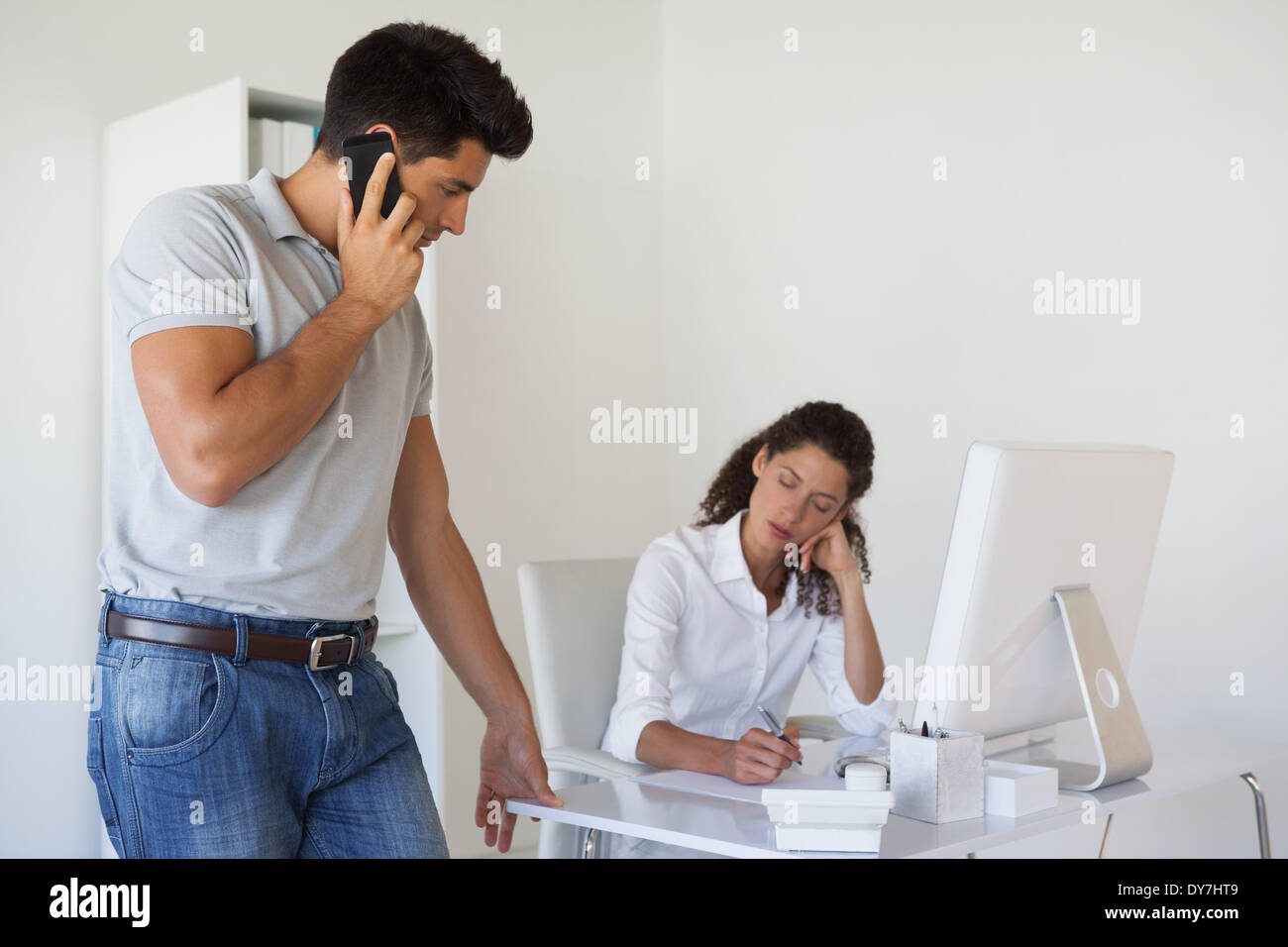 Casual business team working together at desk Stock Photo - Alamy