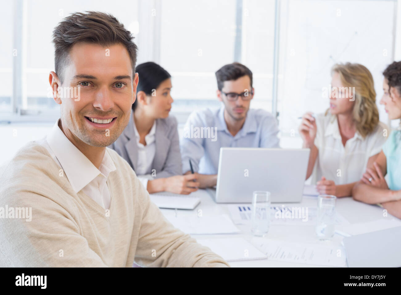 Casual businessman smiling at camera during meeting in the office Stock ...