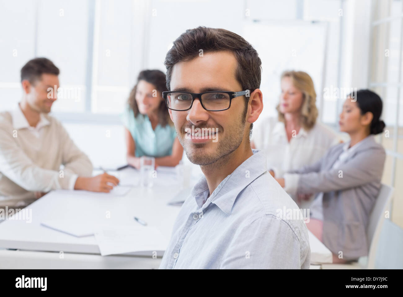 Casual businessman smiling at camera during meeting in the office Stock ...