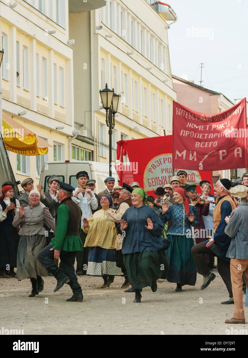 Festive parade on the city street. Demonstrators with posters. Dance ...