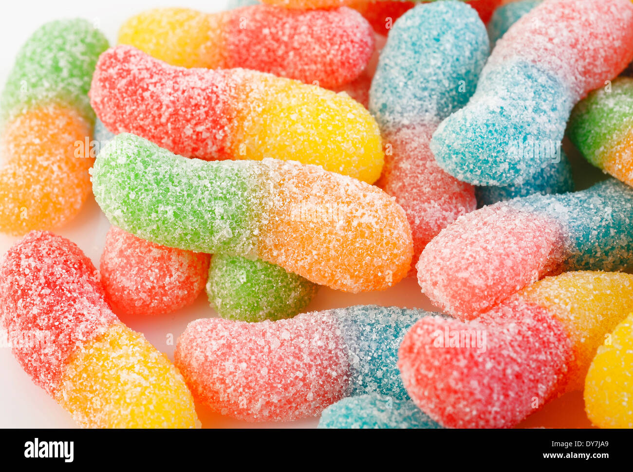gummy worm candies on white background Stock Photo - Alamy