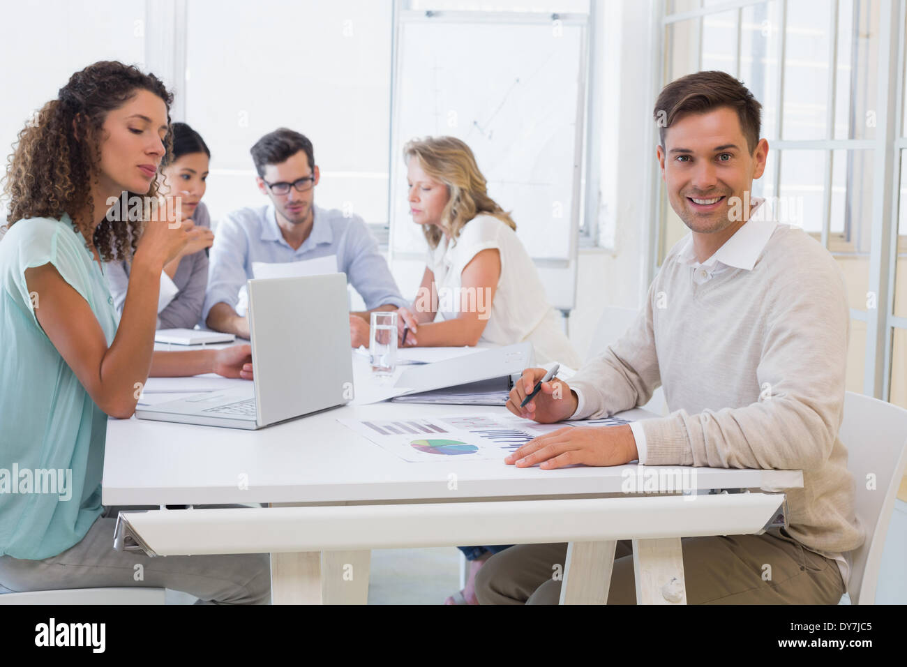 Casual businessman smiling at camera during meeting in the office Stock ...