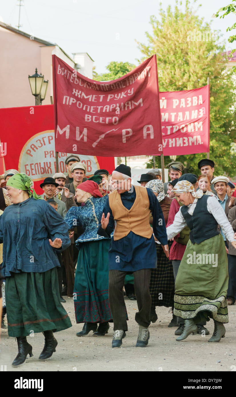 Festive parade on the city street. Demonstrators with posters. Dance ...