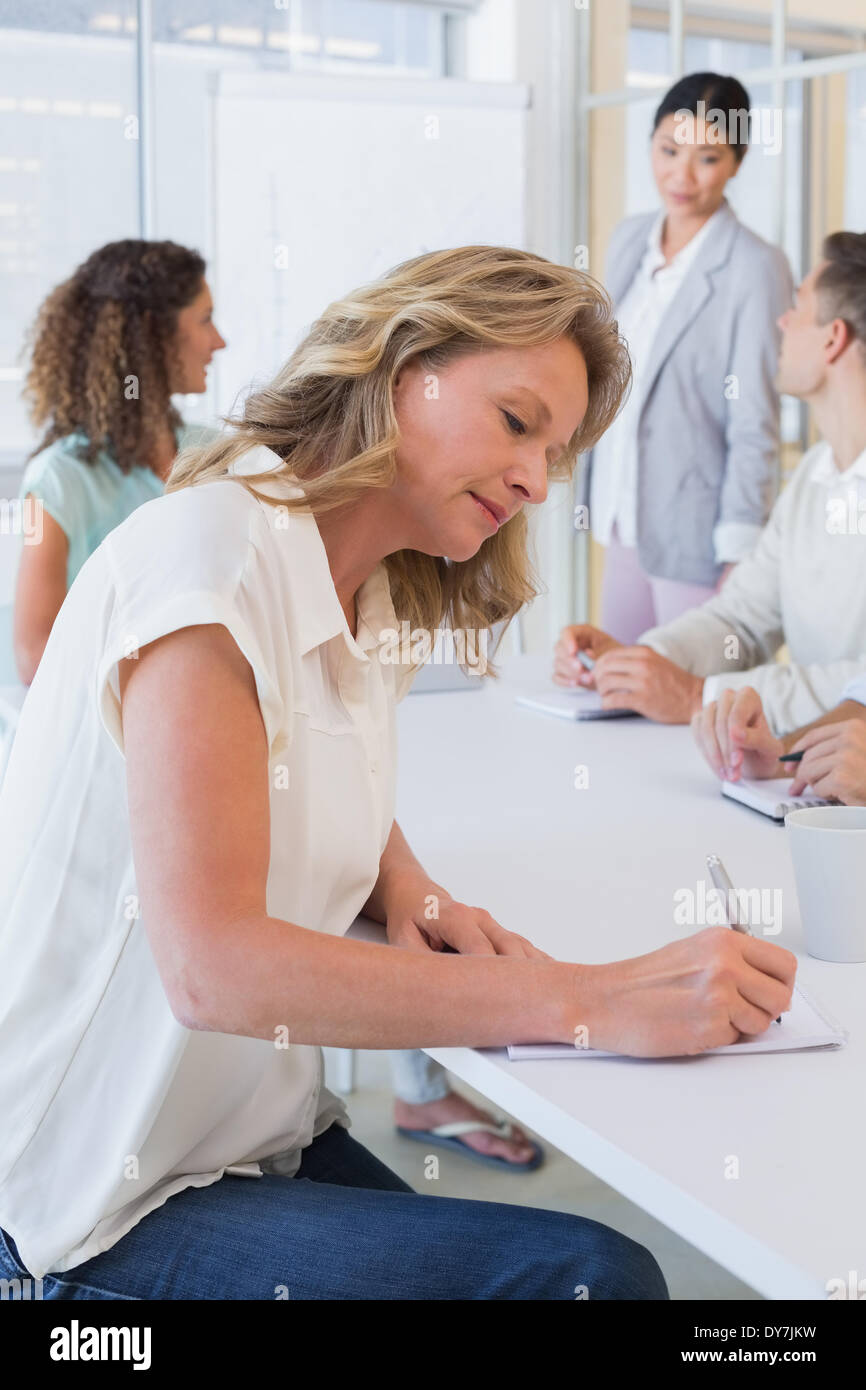 Casual businesswoman taking notes during meeting in the office Stock ...