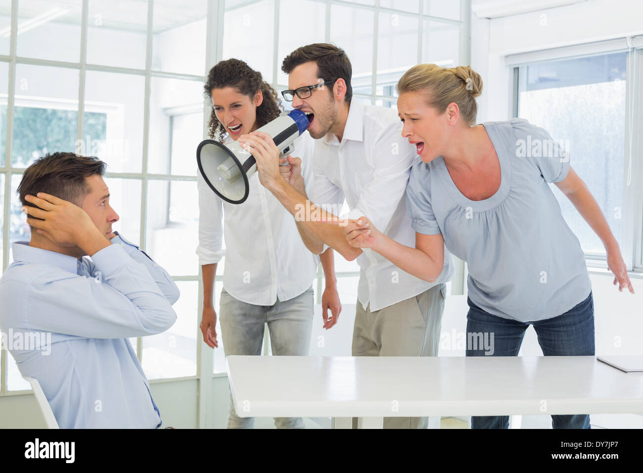 Casual business team shouting at a colleague in the office Stock Photo ...