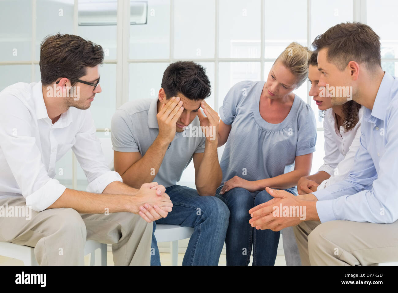 Group therapy in session sitting in a circle Stock Photo - Alamy