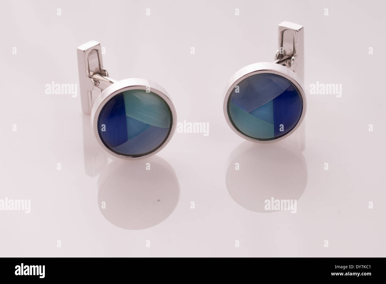 Cat's Eye cuff links isolated on white background with light reflection ...