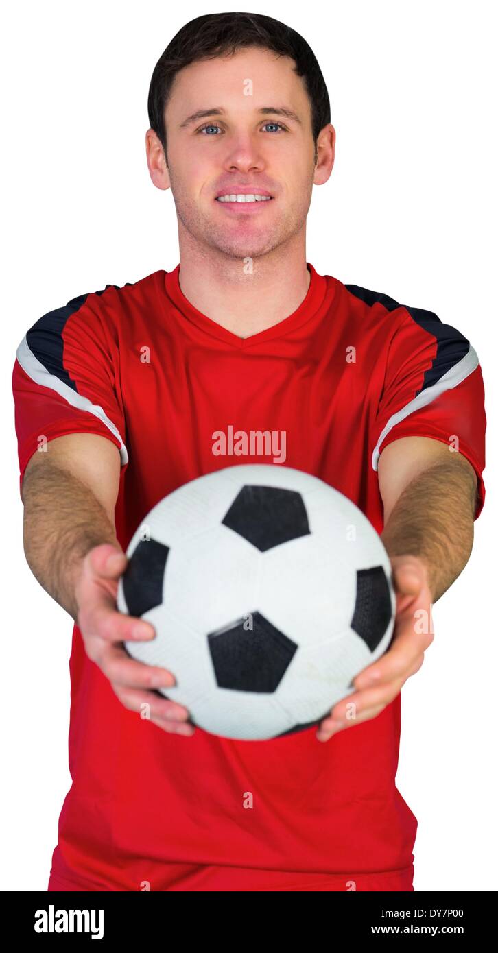 Football fan in red holding ball on white background Stock Photo - Alamy