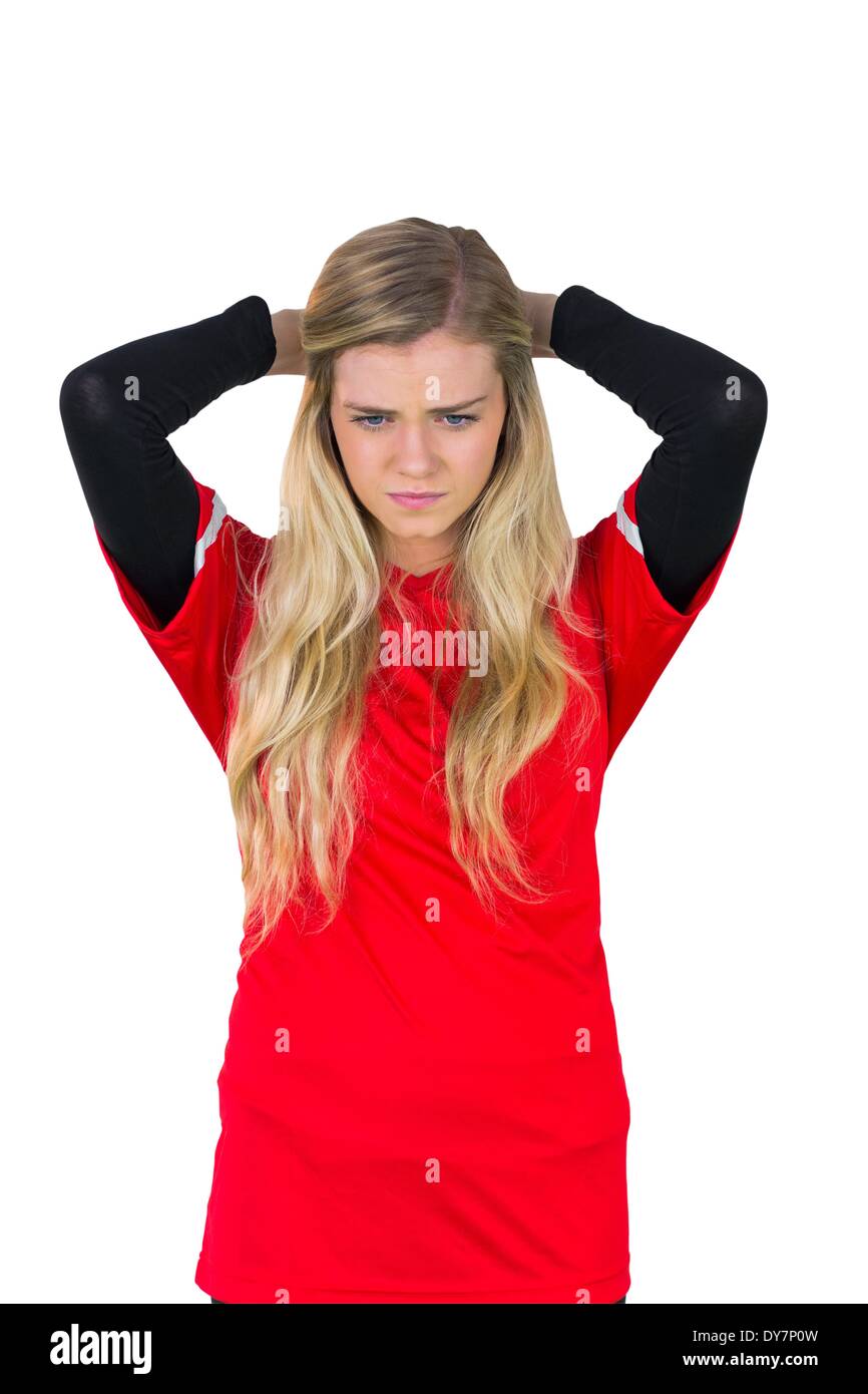 Disappointed football fan in red on white background Stock Photo - Alamy