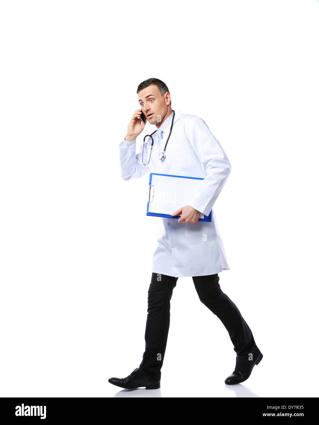 Panicked male doctor running over white background Stock Photo - Alamy