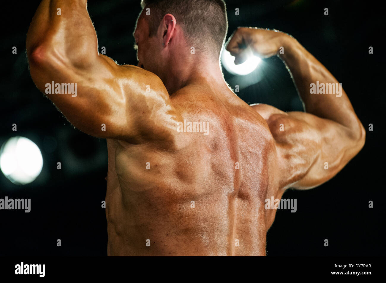 Detail of a male bodybuilder during the fitness fair FIBO in Cologne ...