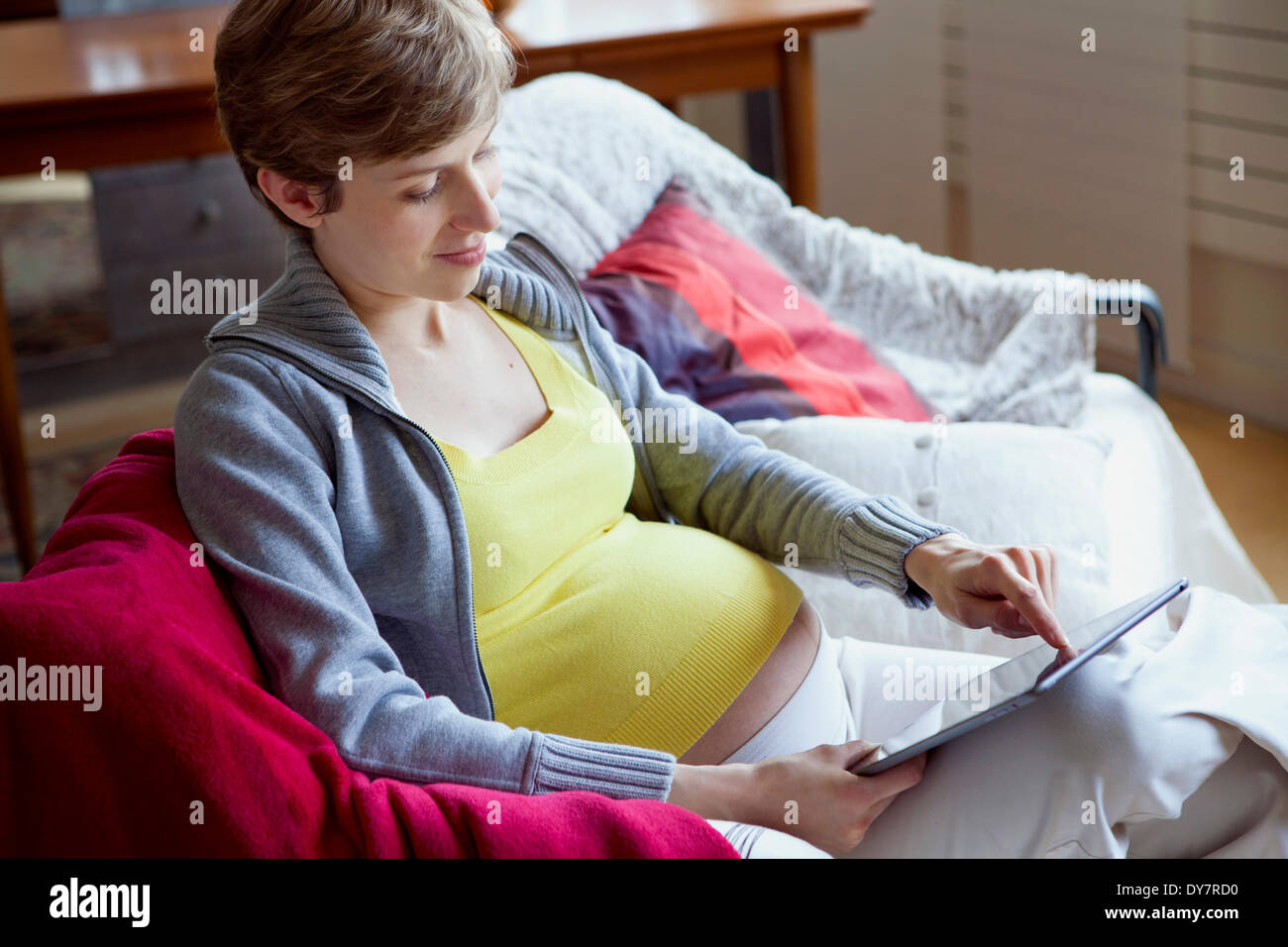 Pregnant lady sofa tablet hi-res stock photography and images - Alamy