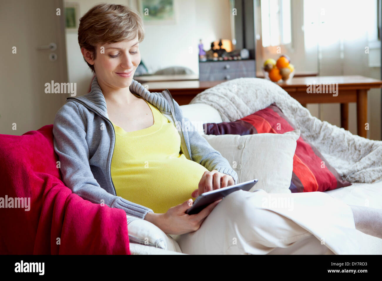 Pregnant woman with tablet Stock Photo - Alamy