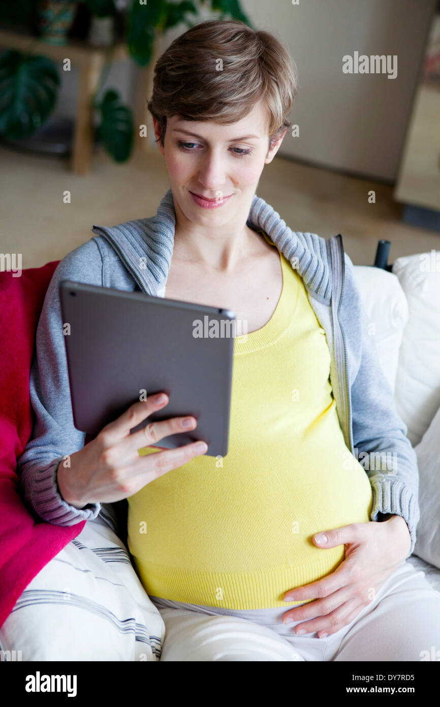 Pregnant woman with tablet Stock Photo - Alamy
