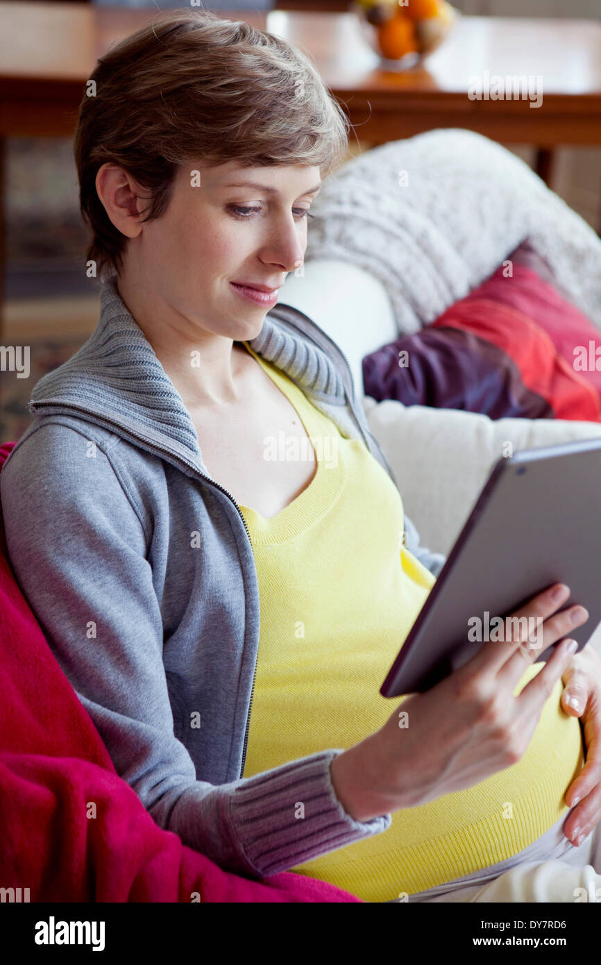 Pregnant woman with tablet Stock Photo - Alamy