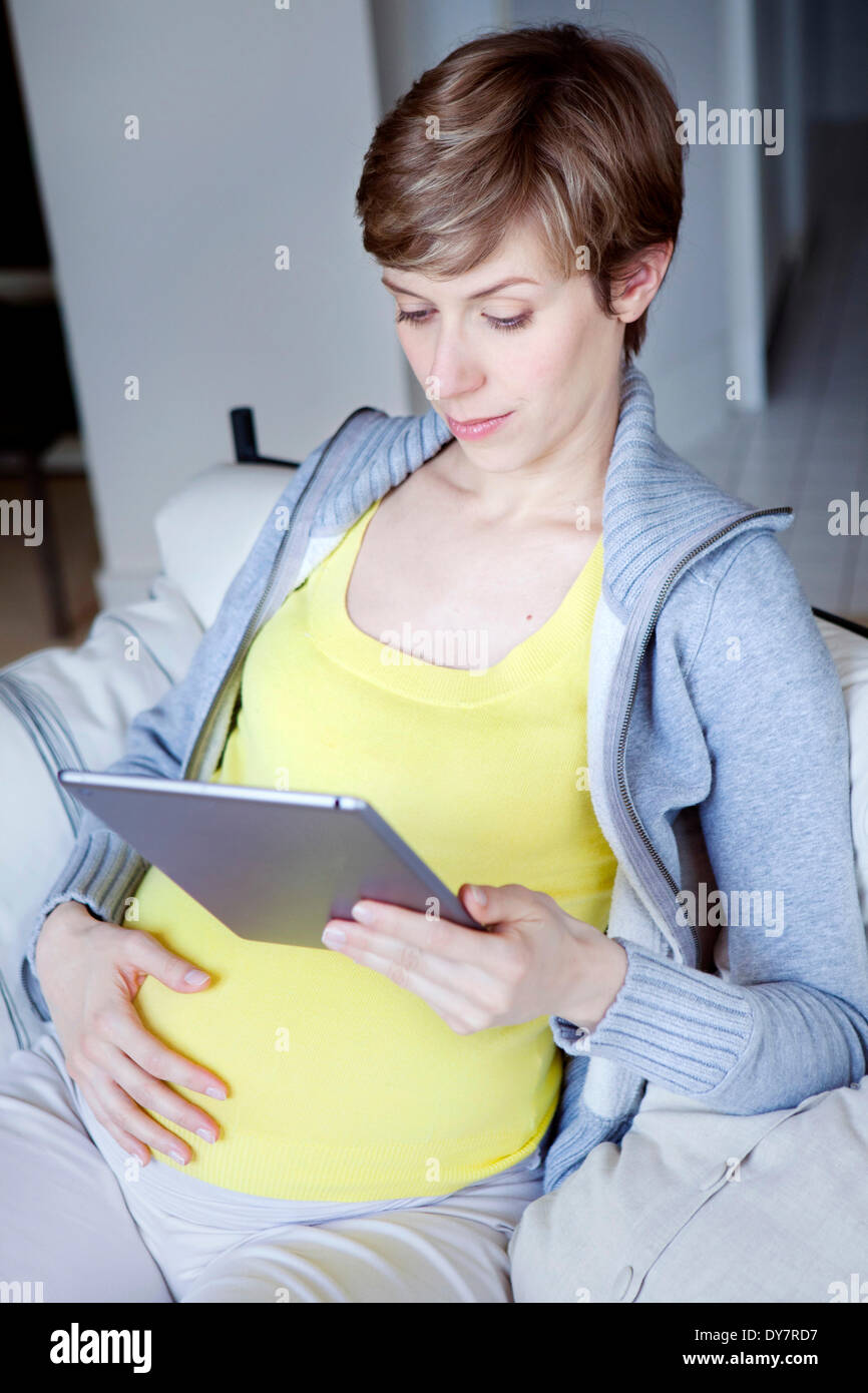 Pregnant woman with tablet Stock Photo - Alamy