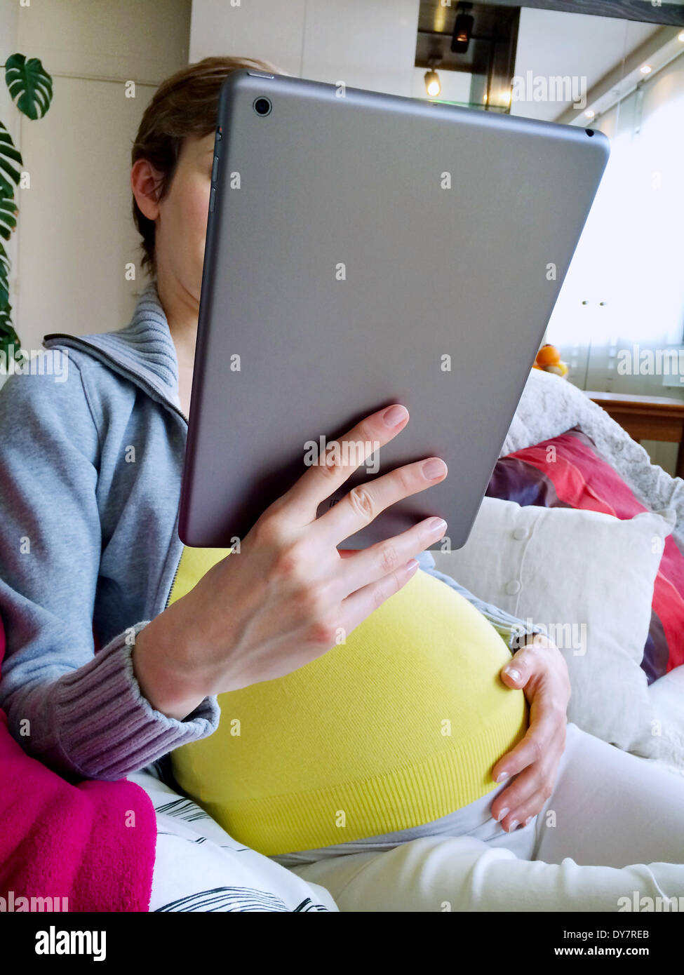 Pregnant woman with tablet Stock Photo - Alamy