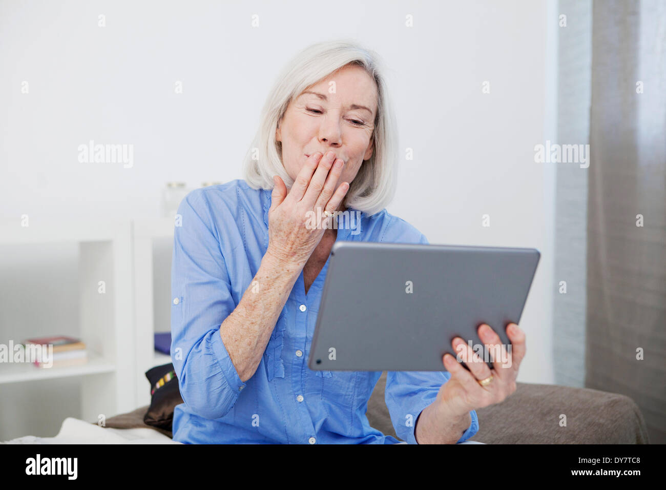 Elderly person with tablet Stock Photo - Alamy